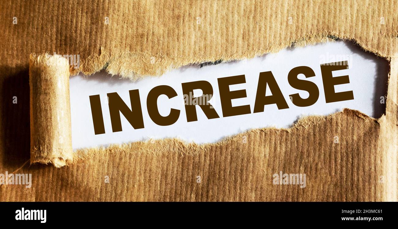 Increase word written on brown torn cardboard. Success text on table ...