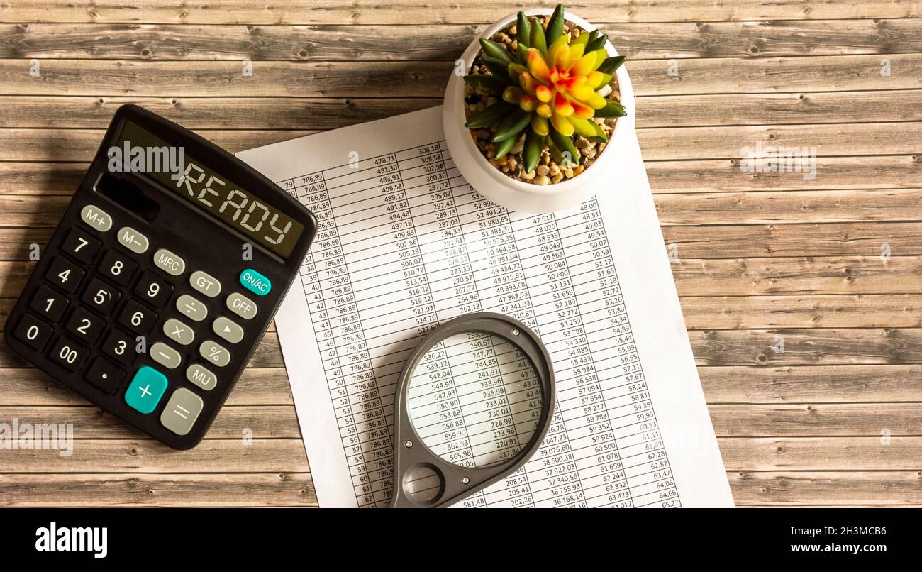 Ready, the text is written on the calculator. Magnifier, papers and ...