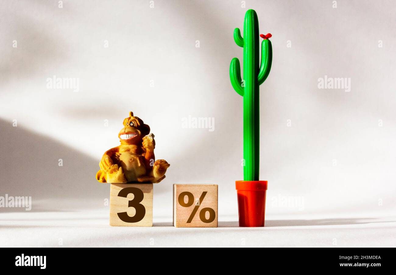3 percent on wooden cubes, white background with monkey and palm ...
