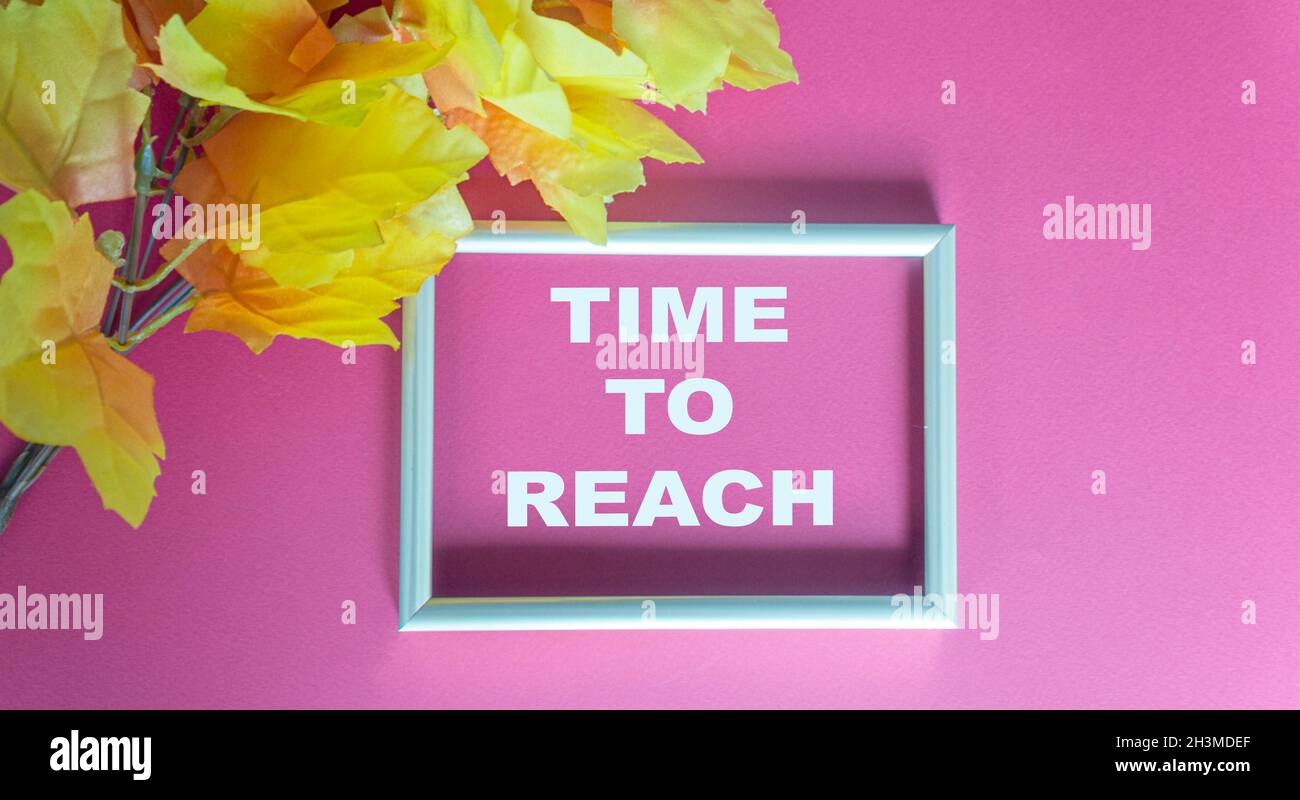time to reach, text in silver frame on yellow foliage and red ...