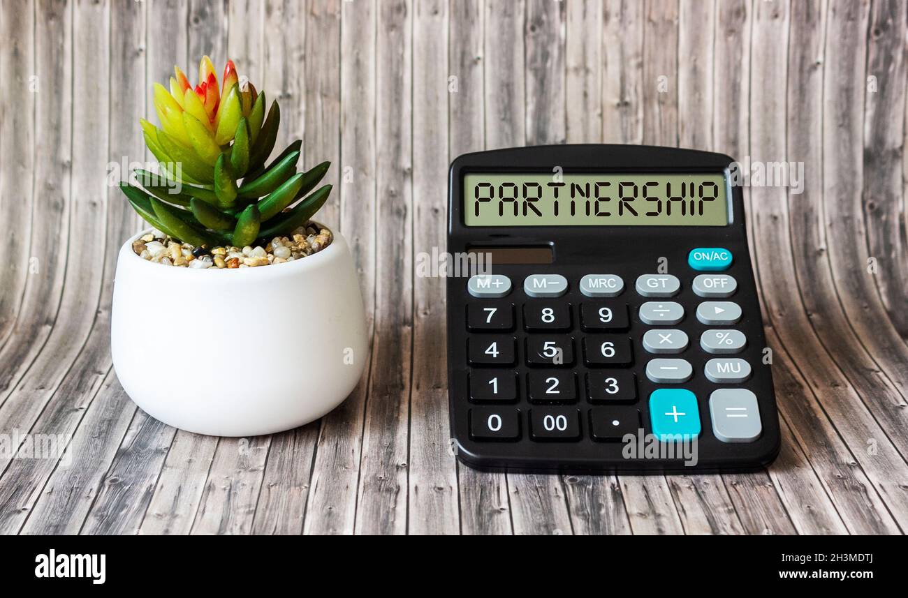 Word PARTNERSHIP on calculator. Business and tax concept Stock Photo ...