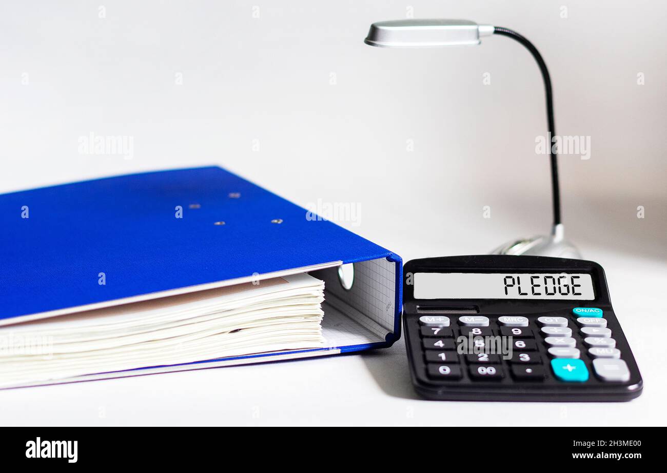 Pledge - word written on calculator display, deposit, guarantee, pledge ...