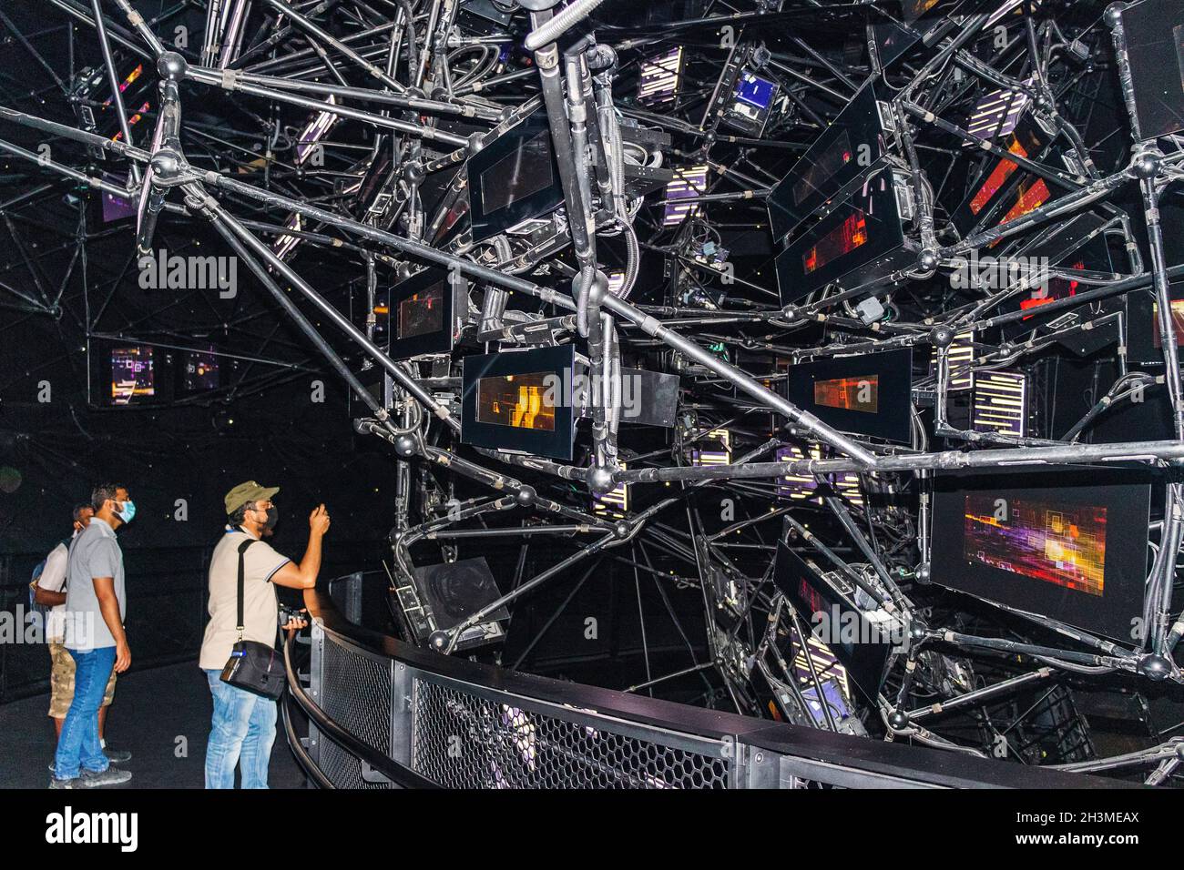 Dubai, UAE - 10.16.2021 Visitors inspecting futuristic installation ...