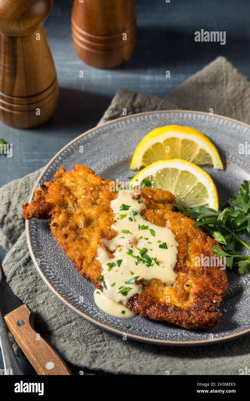 Homemade German Chicken Schnitzel with Lemon and Sauce Stock Photo - Alamy