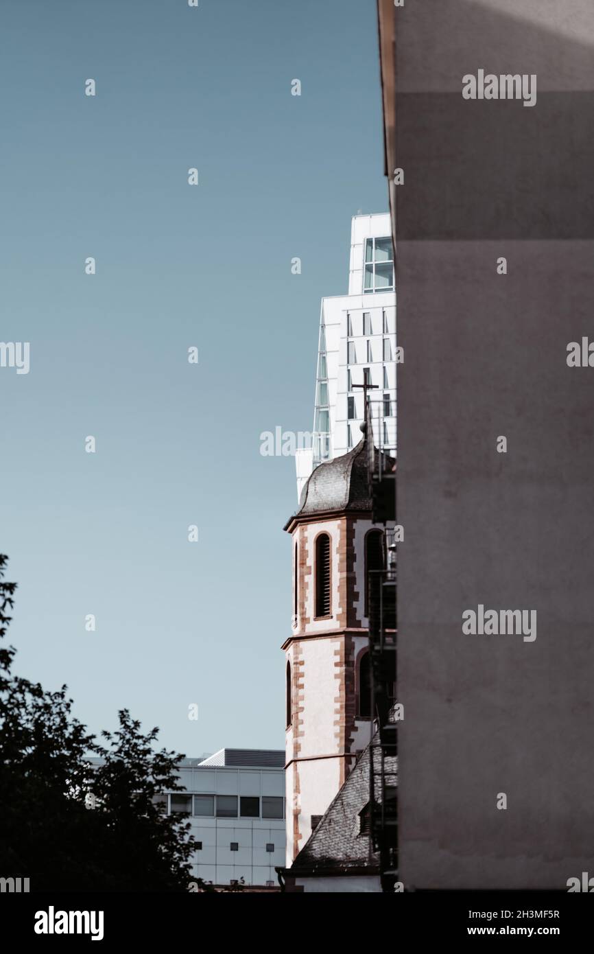 Vertical view of the church behind the buildings Stock Photo - Alamy