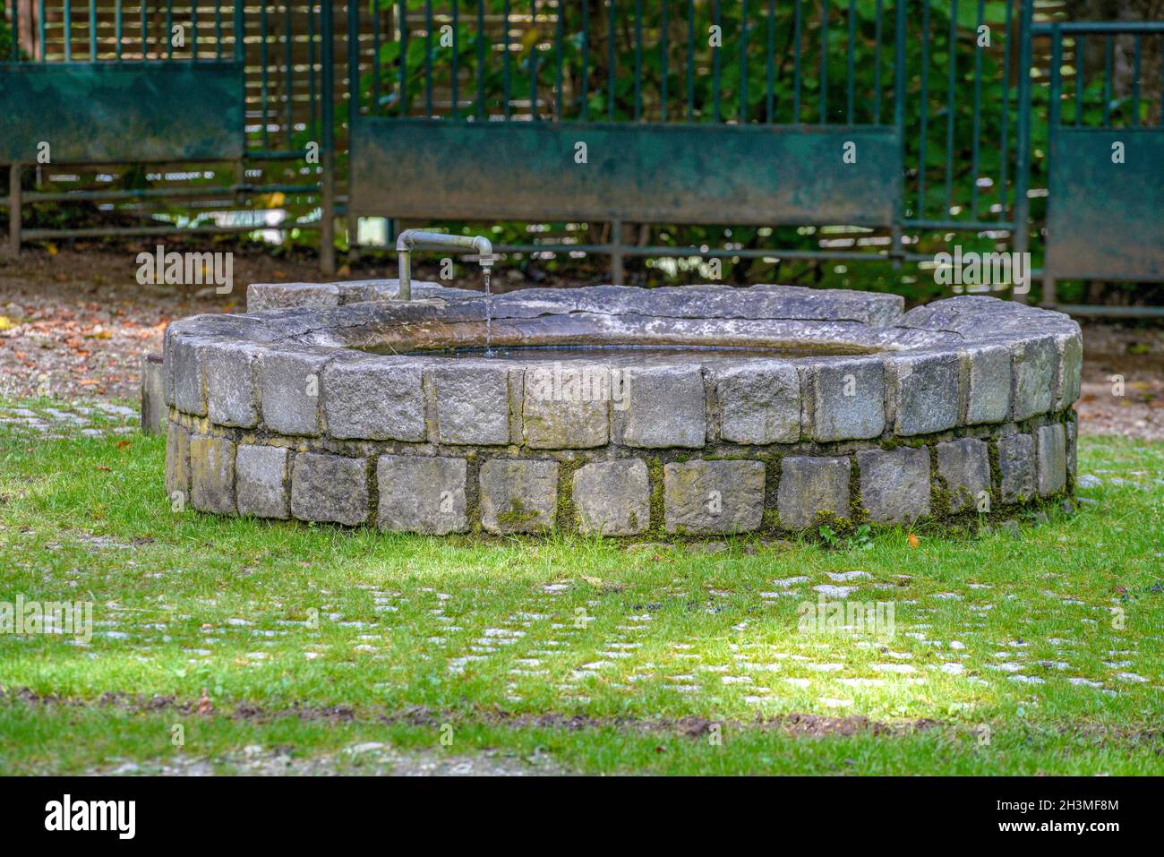 Well with a tap outdoors in daylight Stock Photo - Alamy