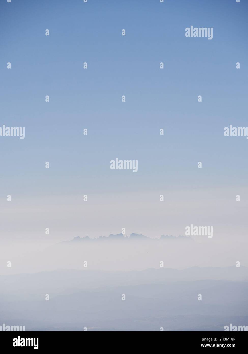 Vertical shot of the hills in the distance. Blue background Stock Photo ...