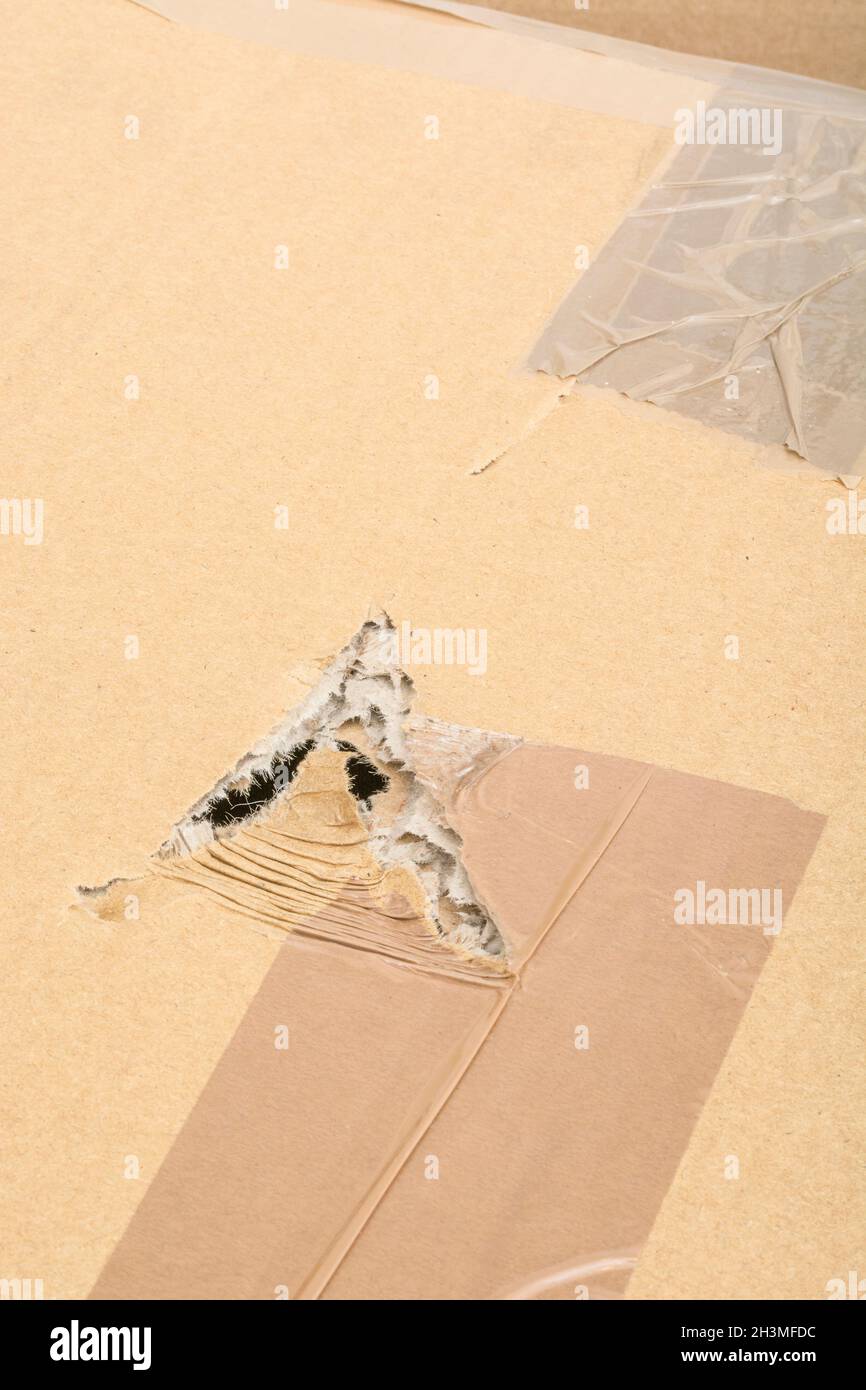 Visible signs of damage to a cardboard shipping box damaged in transit ...