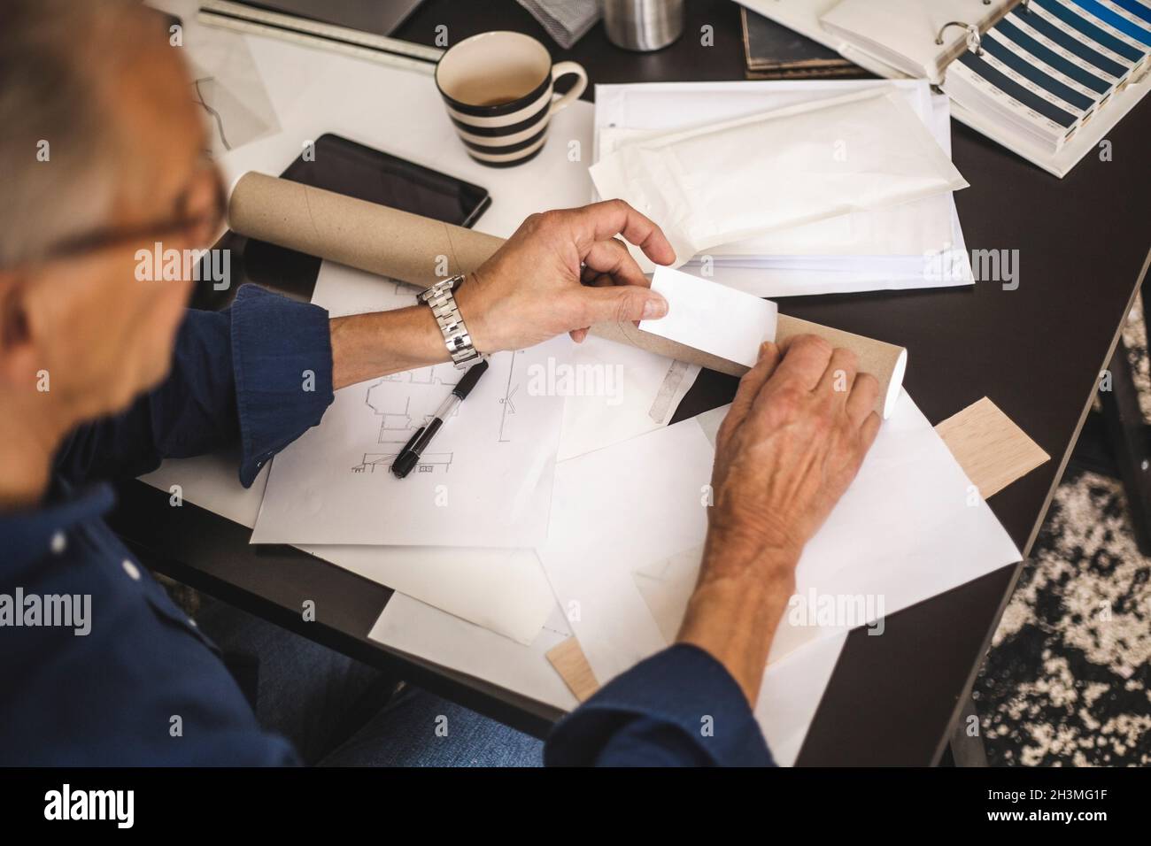 Male owner labeling on envelope at shop Stock Photo - Alamy