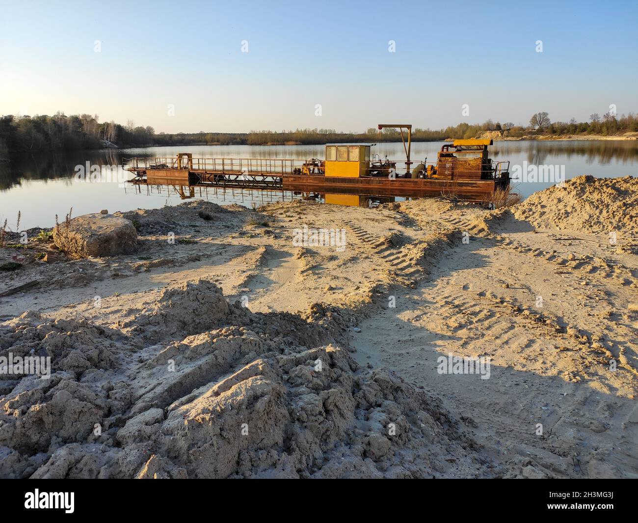 Excavation machine at earthmoving work in sand quarry. Extraction of ...