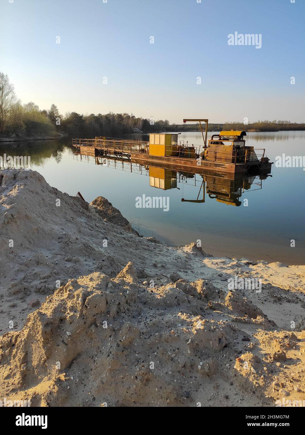 Excavation machine at earthmoving work in sand quarry. Extraction of ...