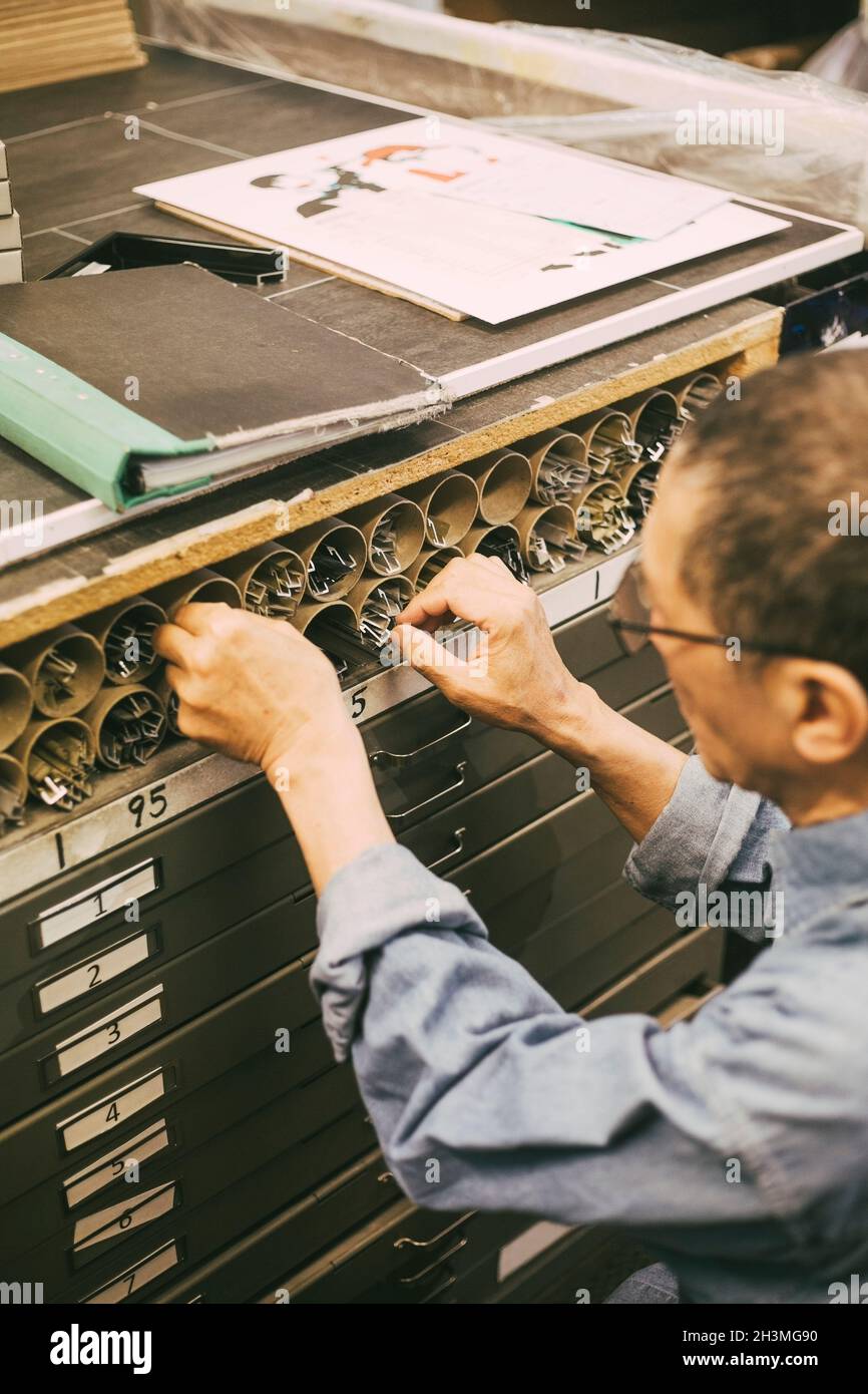 Craftsman arranging frames in rack at workshop Stock Photo - Alamy
