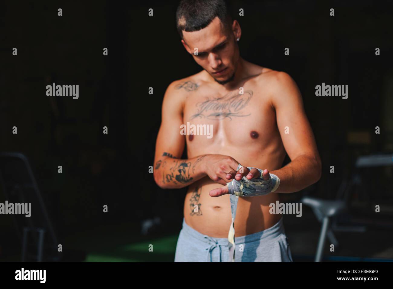 Latino boy putting bandages on his hands before a boxing match Stock ... Latino boy putting bandages on his hands before a boxing match Stock ...