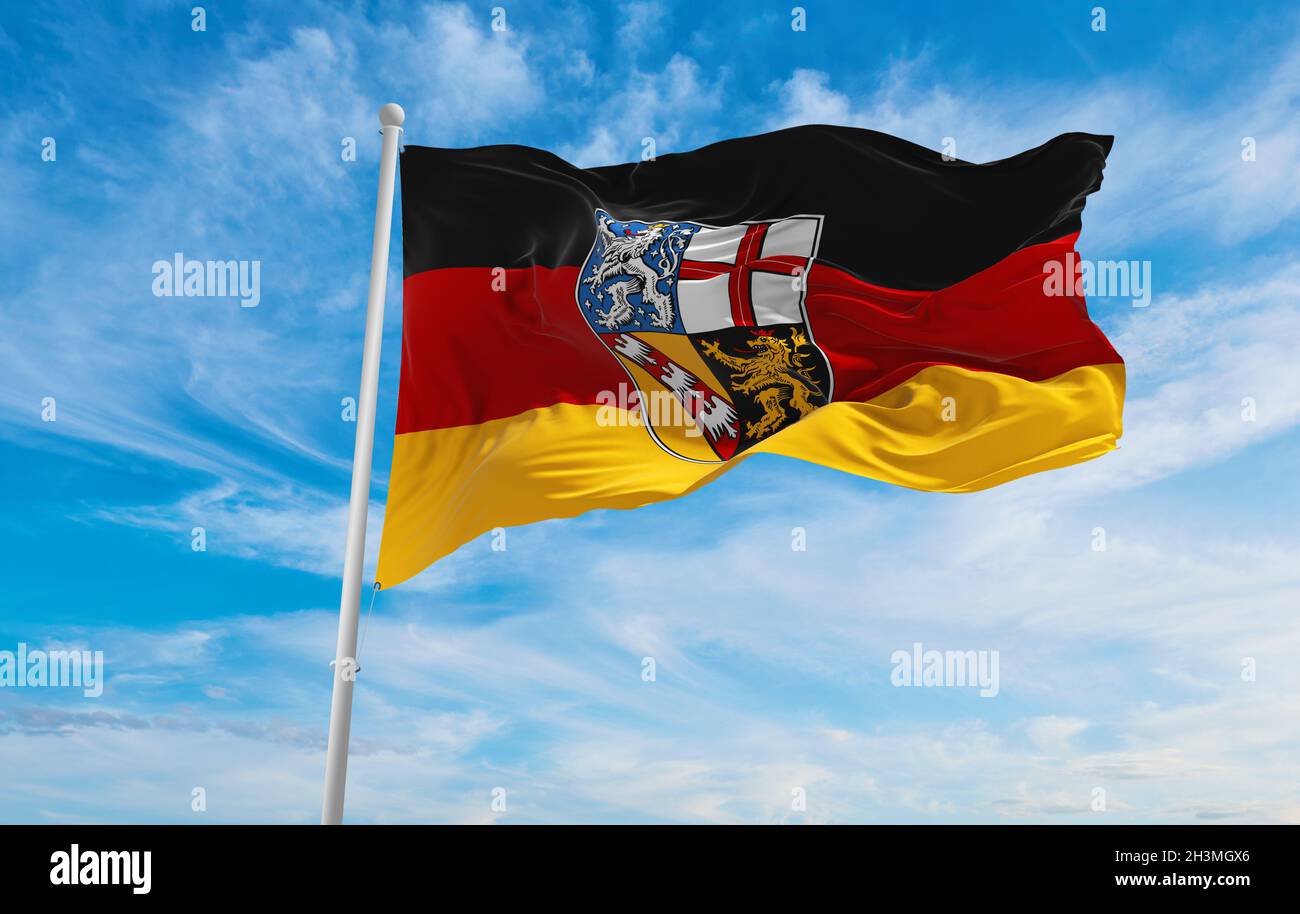 flag of Saarland at cloudy sky background on sunset, panoramic view ...