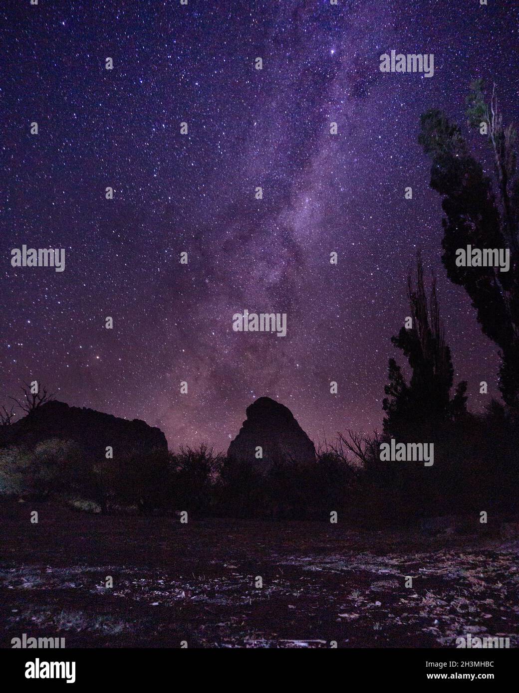 Milky way stars falling in a rock formation in patagonia Stock Photo ...
