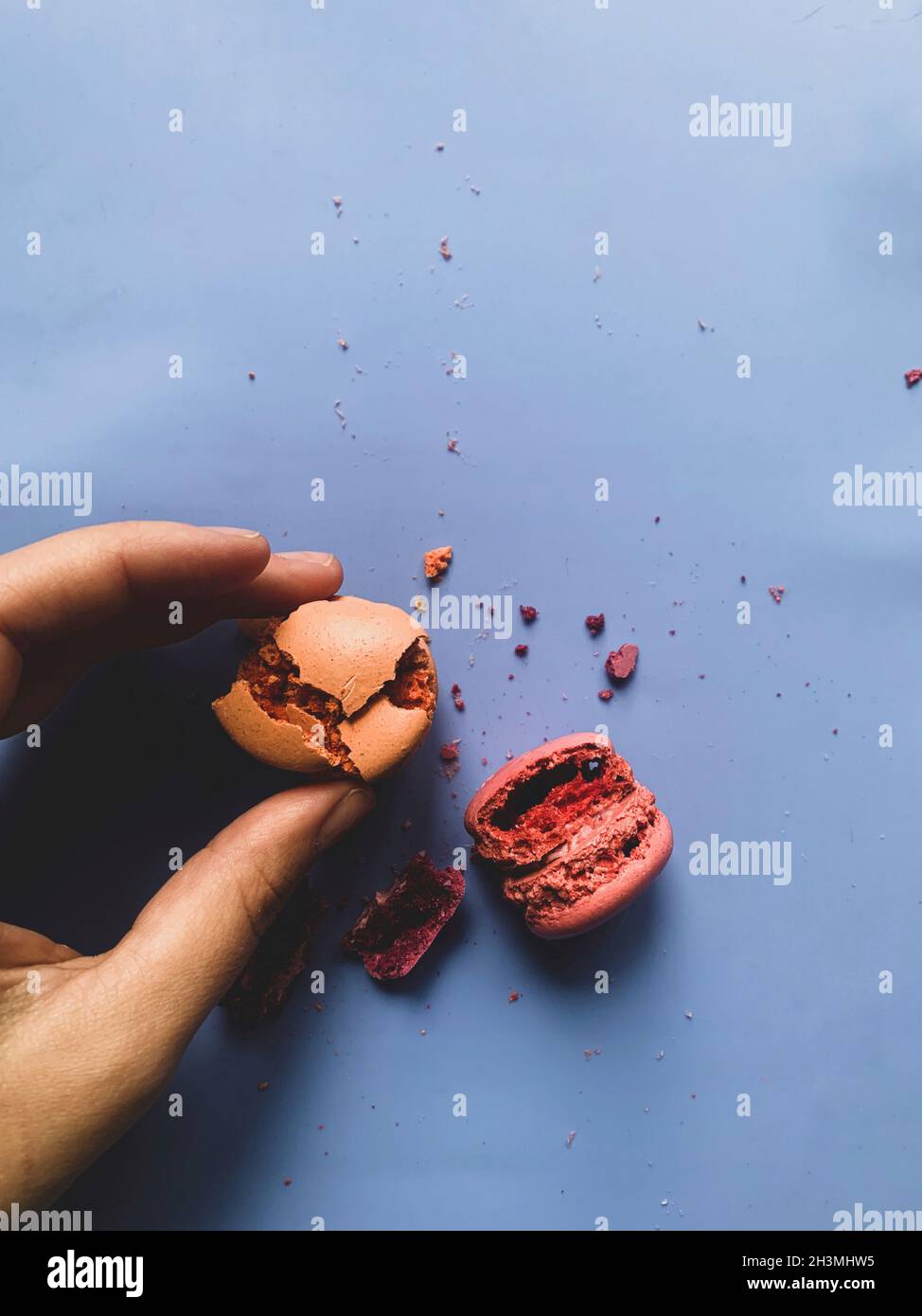 Girl holding macaroon in her hand Stock Photo - Alamy