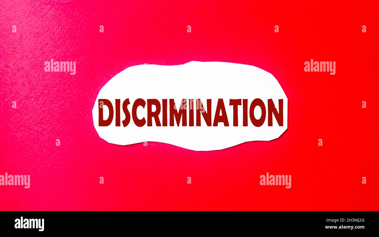 Discrimination written on a scrap of paper and a red background ...
