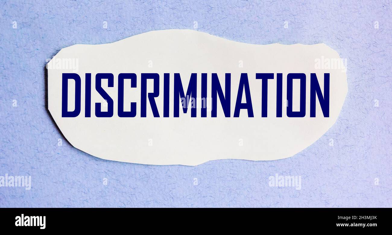 The word discrimination is written on a piece of paper that lies on a ...