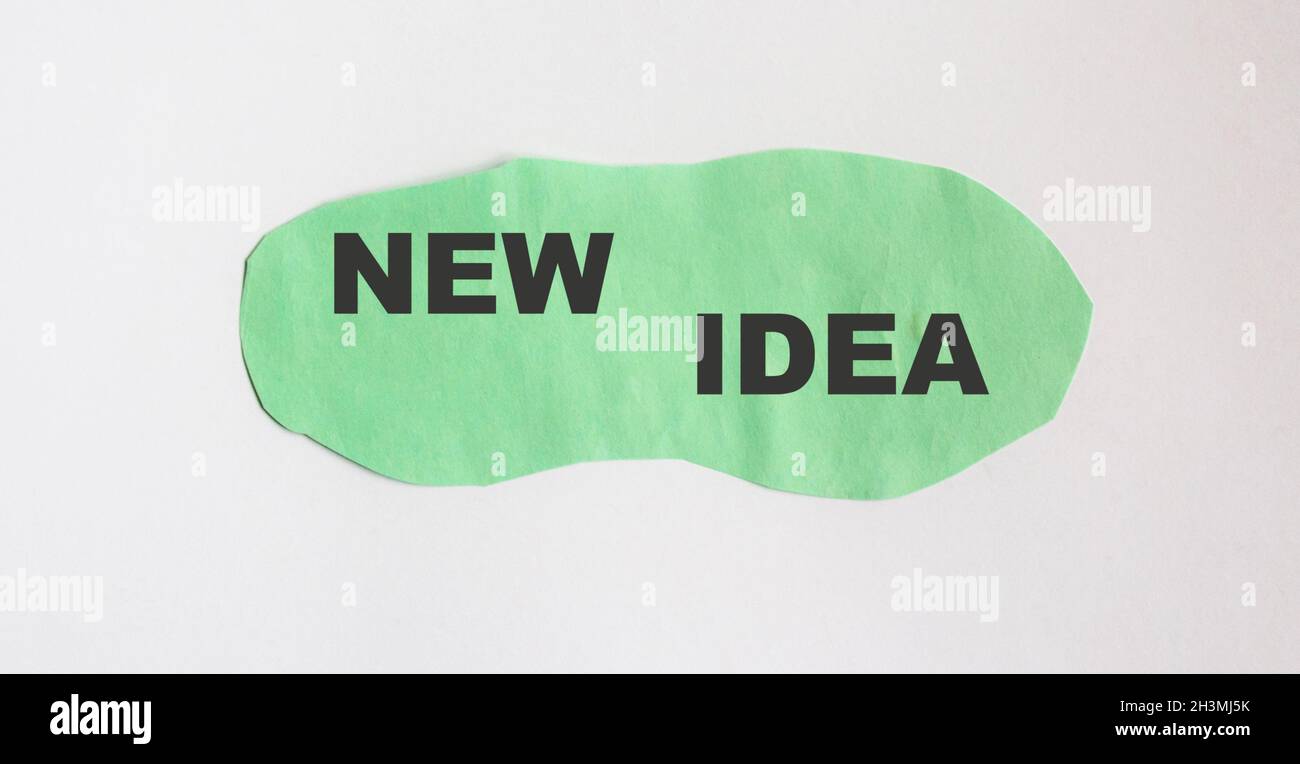 A new idea, the text is written on a piece of note paper and on a light ...