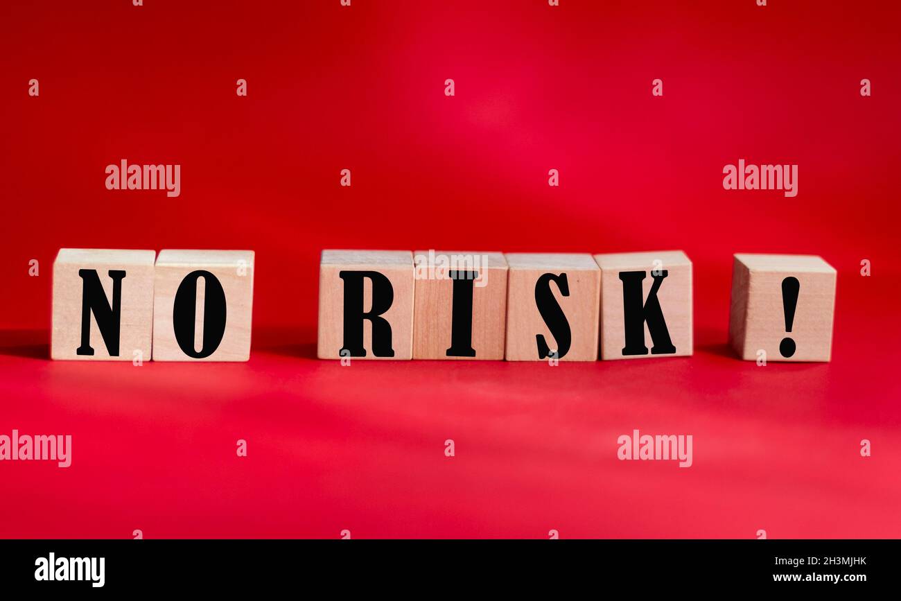 Wooden cubes with the text NO RISK on a red background. Negative answer ...