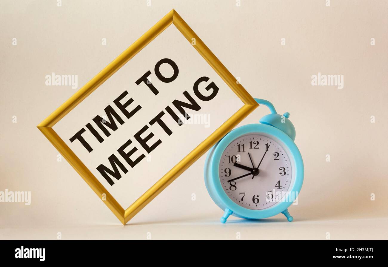 Time for a meeting, the text is written on a gold frame, next to an ...