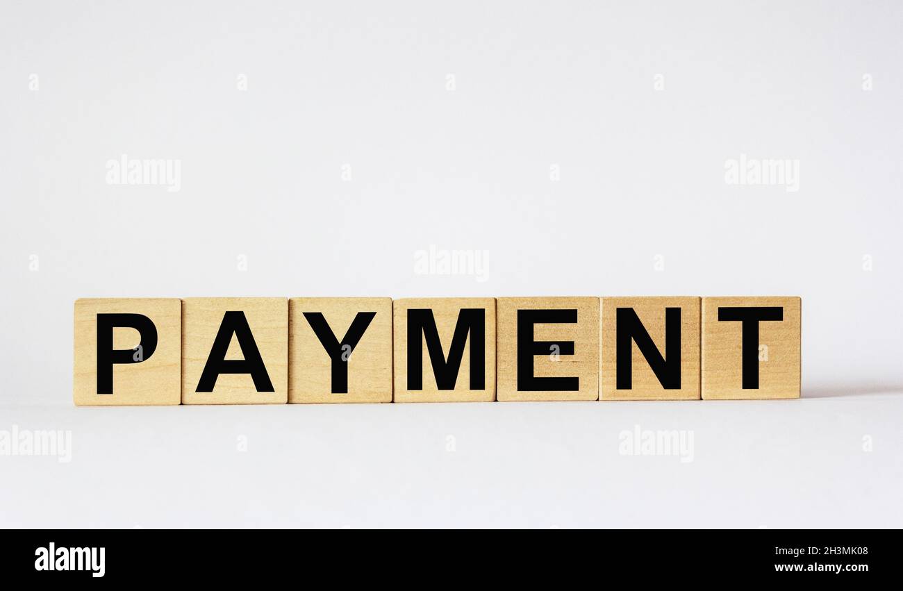 Wooden blocks with the text: PAYMENT. Text written in black letters ...