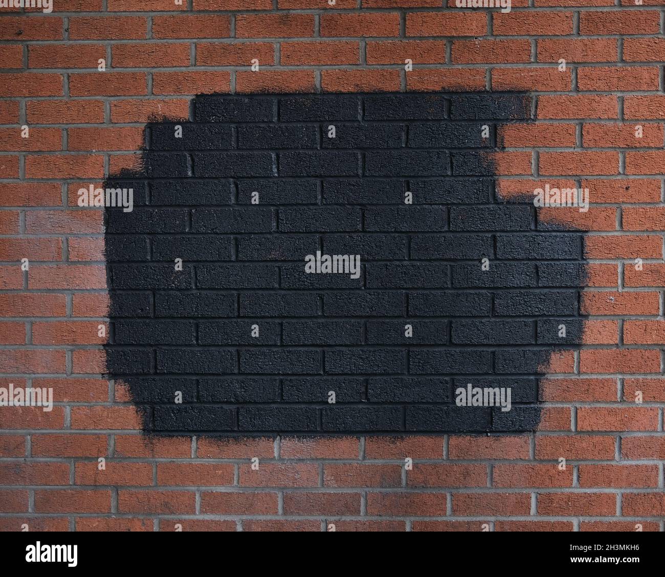 October 2021 - Blank brick wall with a black painted patch covering ...