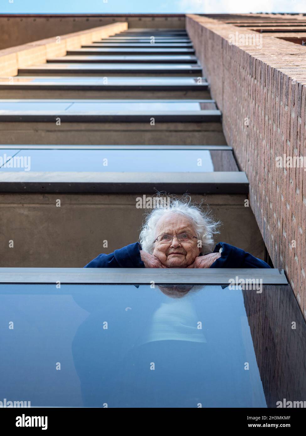 Retirement home in Pandemic Lockdown: A senior woman stares out from ...