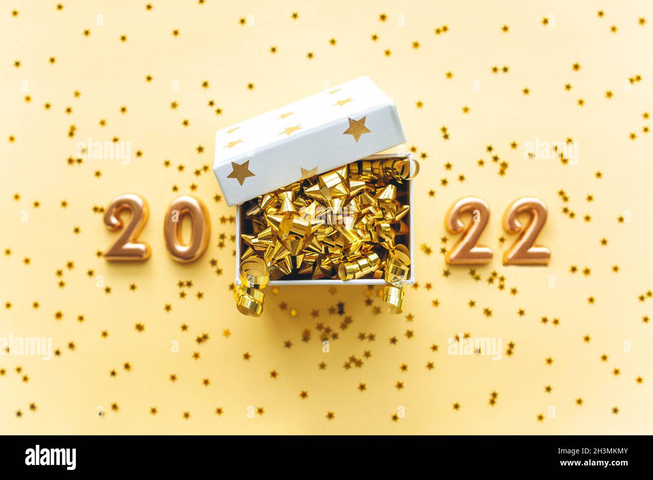 Open gift white box with confetti and numbers 2022 on a gold background ...