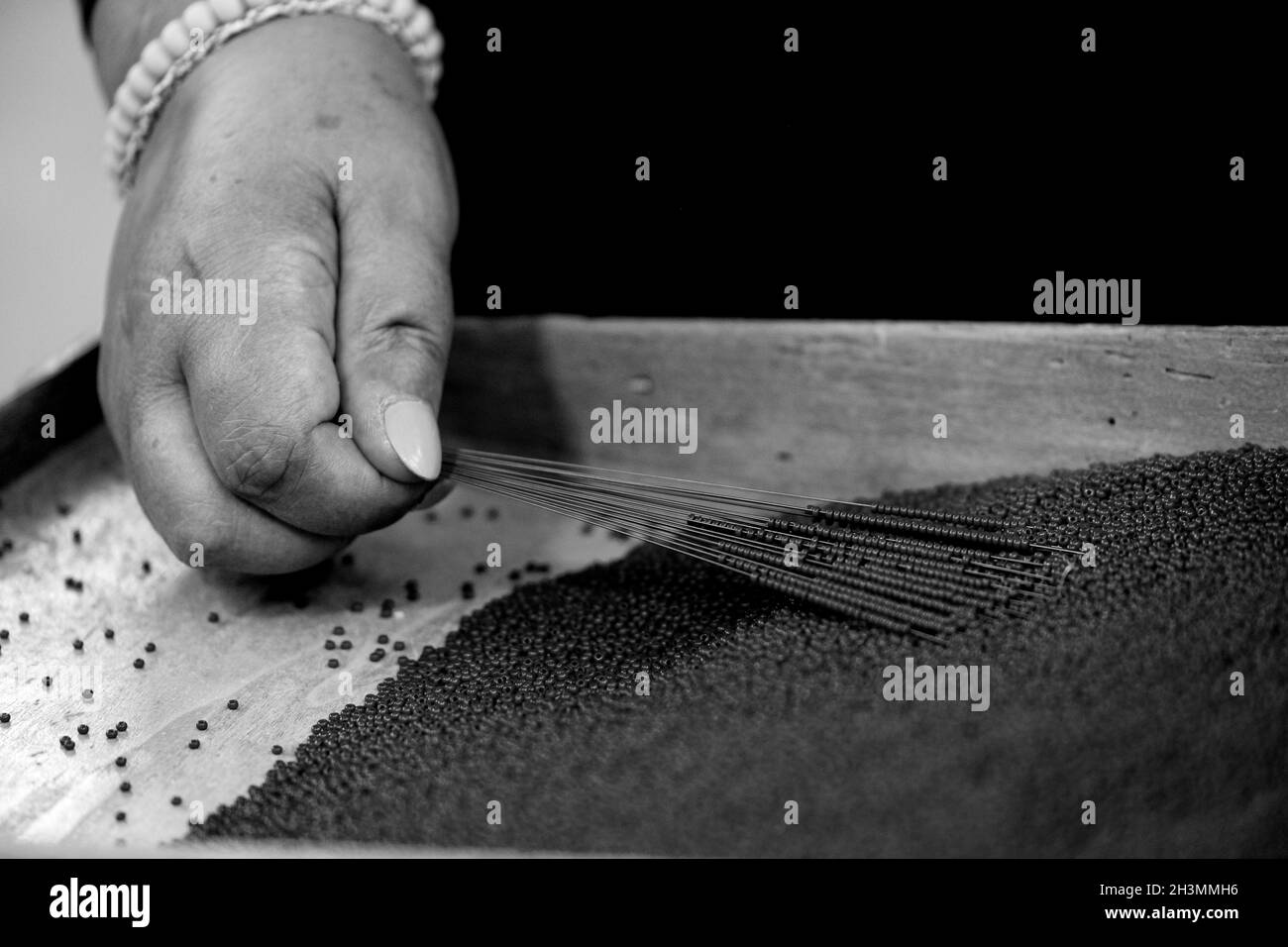 The hands of an impiraressa, the traditional Venetian beads threader ...