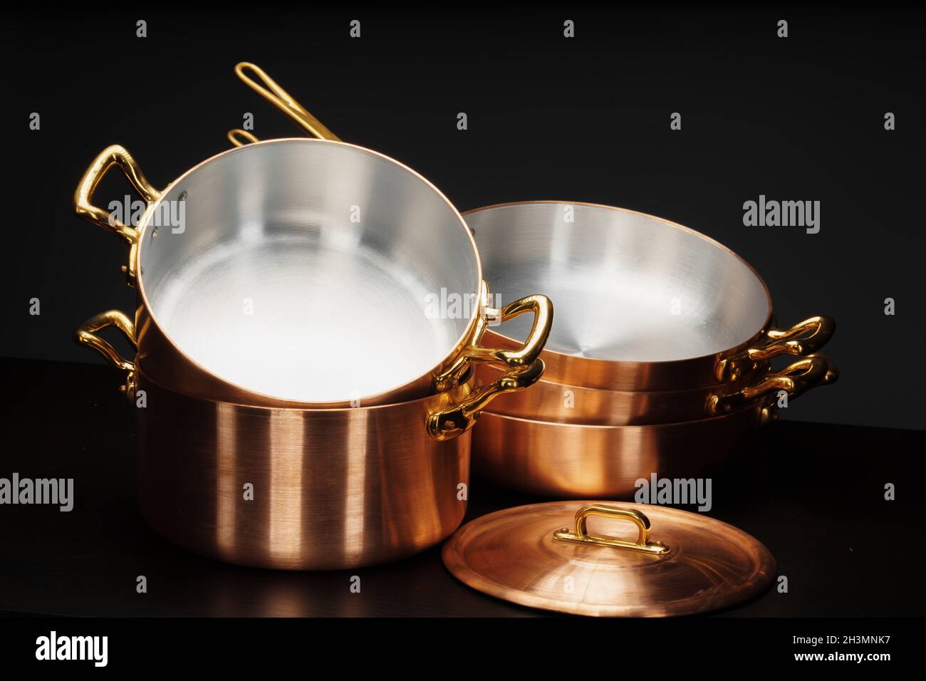 Set of copper cookware over dark background Stock Photo - Alamy