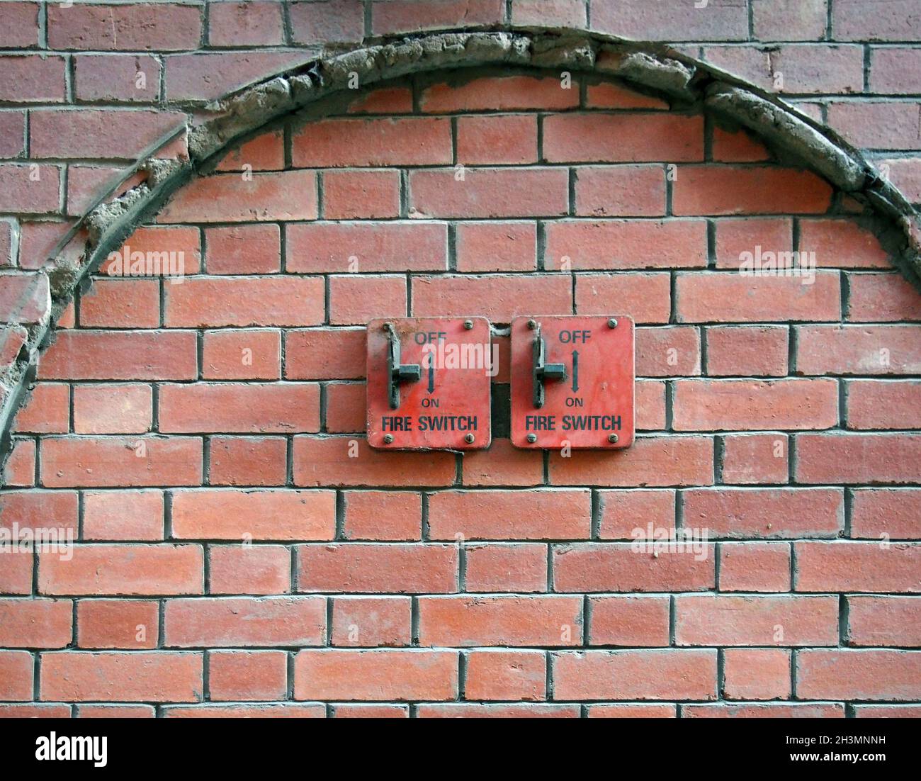 Two old red metal fire switches on an exterior brick wall Stock Photo ...