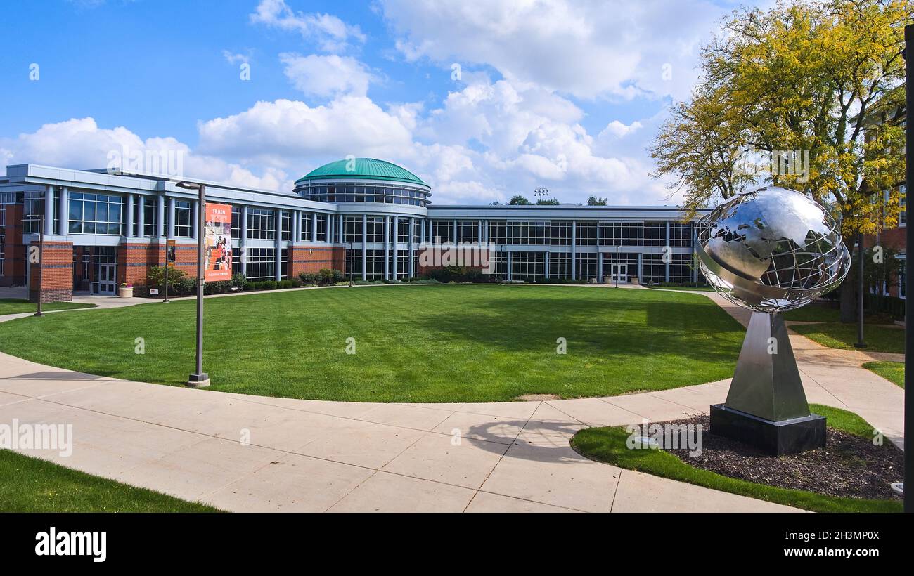 Globe sculpture and architecture of beautiful college campus building ...