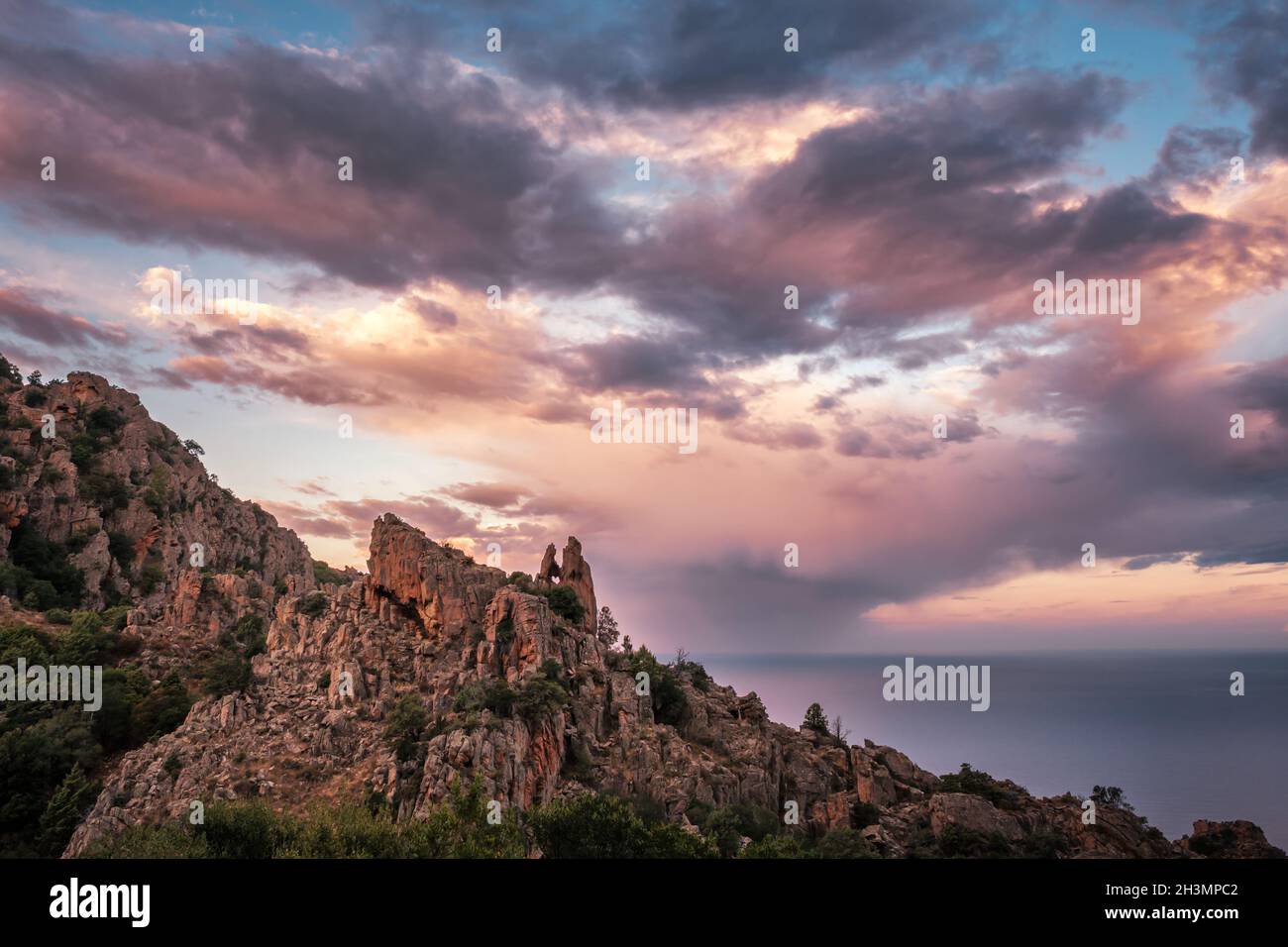 Dramatic morning sky behind the heart shaped hole in the rock of the ...