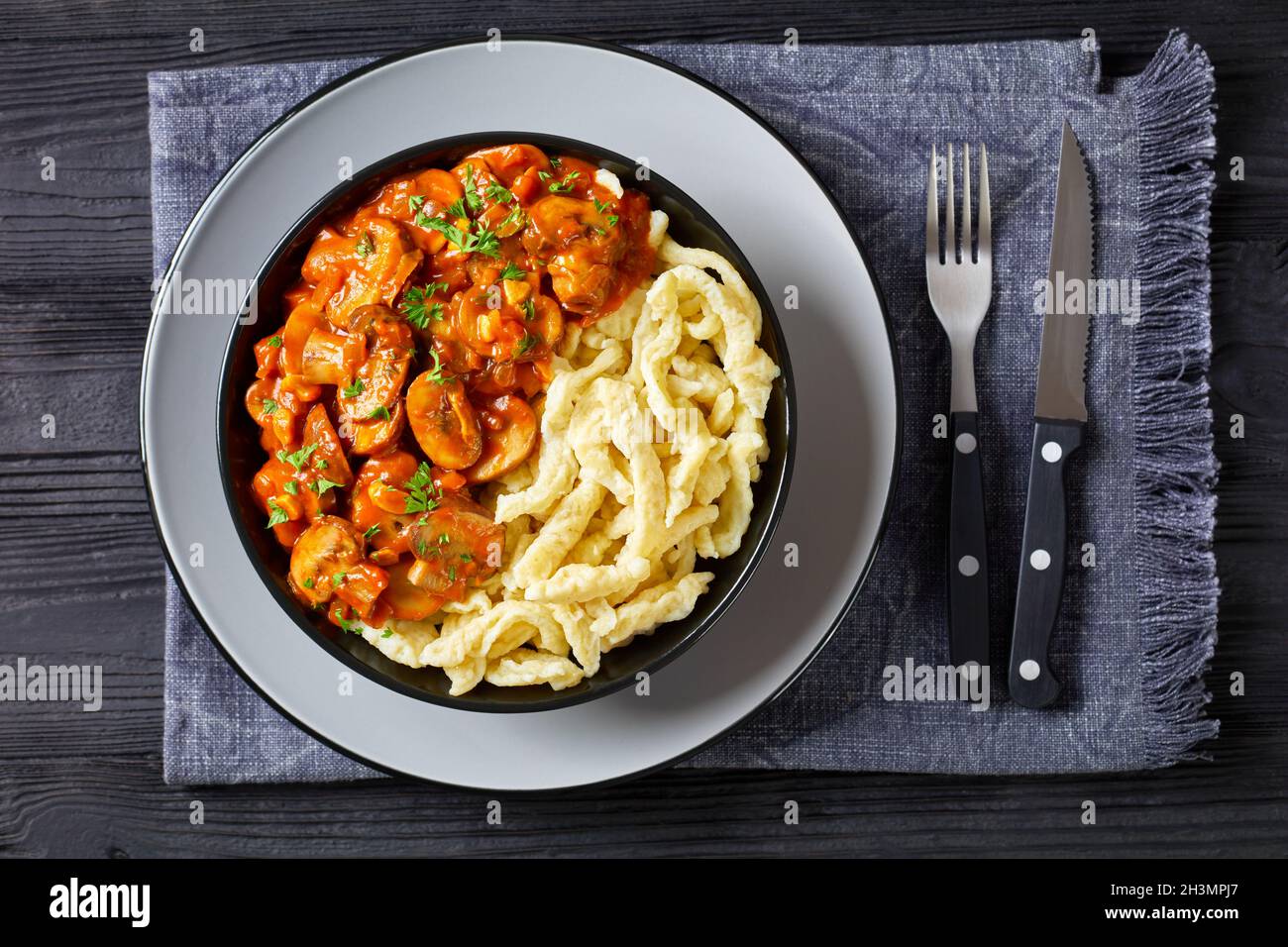 spaetzle with mushroom gravy in a black bowl, jagerspatzle ...
