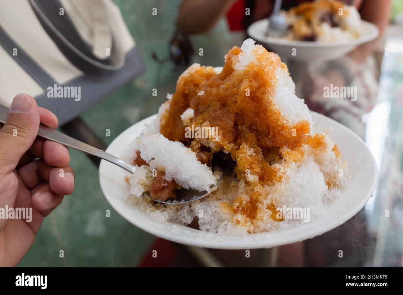Eating shaved ice with colorful dessert Stock Photo - Alamy