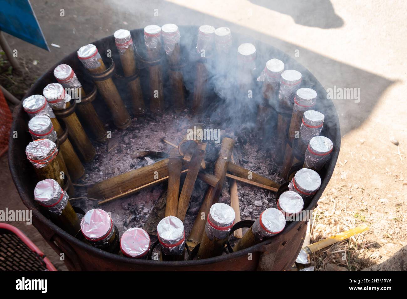Rice cooked in bamboo tubes Stock Photo - Alamy