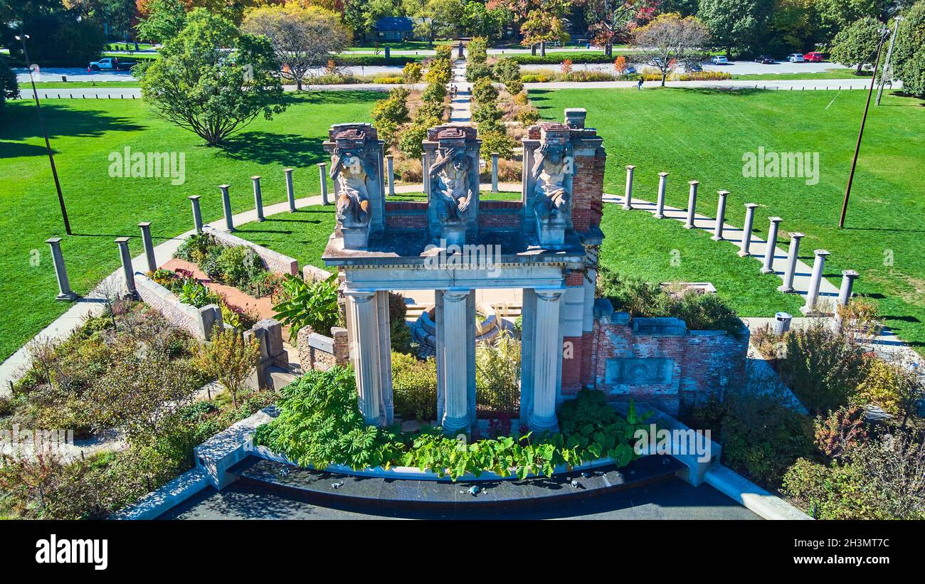 Old ruins in park with three stone columns and large statues Stock ...