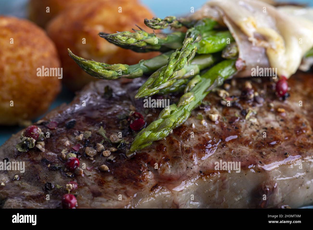Green asparagus on a steak Stock Photo - Alamy