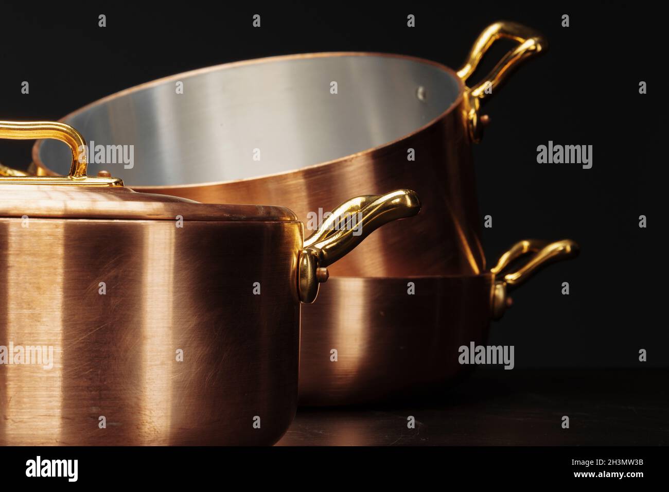 Set of copper cookware over dark background Stock Photo - Alamy