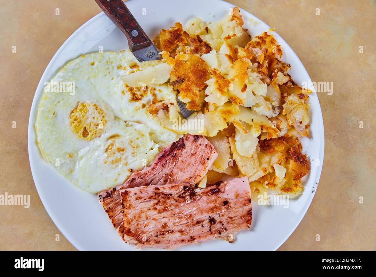 Simple breakfast plate looking down with ham, eggs, and potatoes Stock ...