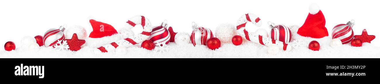 Christmas border of red and white decorations in snow. Side view ...