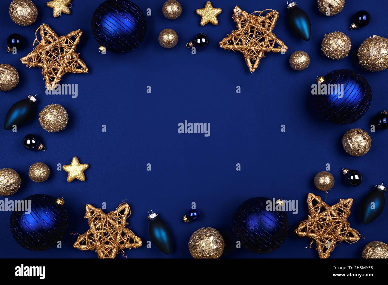 Christmas frame of dark blue and gold ornaments. Above view on a ...