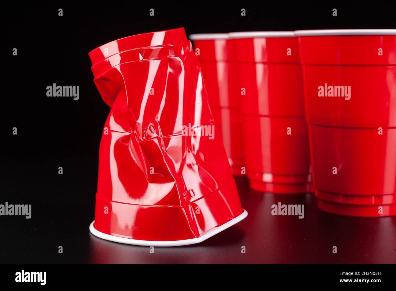 Red plastic cups and ball for game of beer pong Stock Photo - Alamy