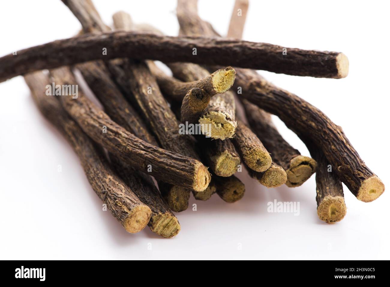 Licorice roots on white background Stock Photo - Alamy