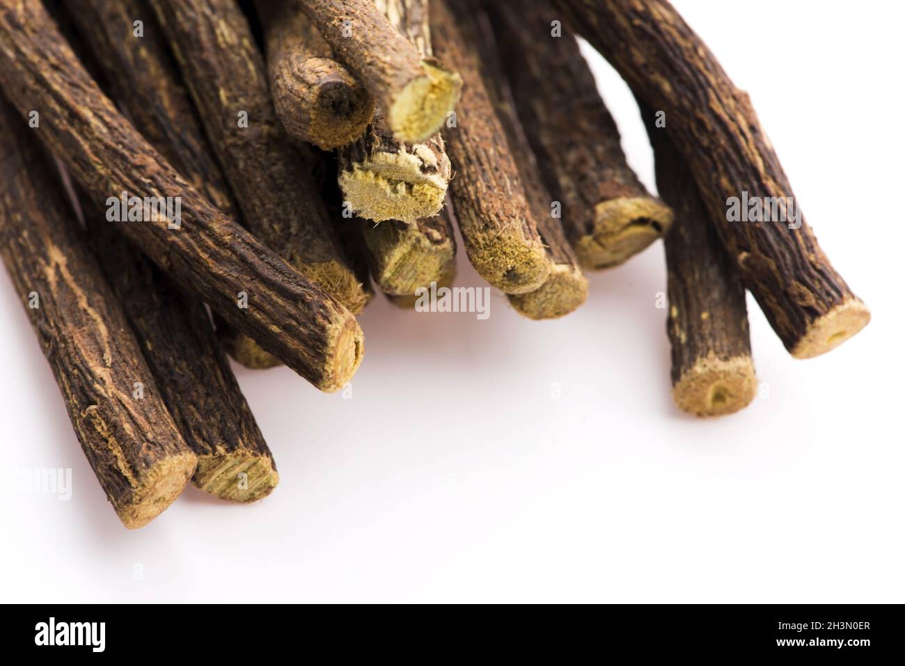 Licorice roots on white background Stock Photo - Alamy