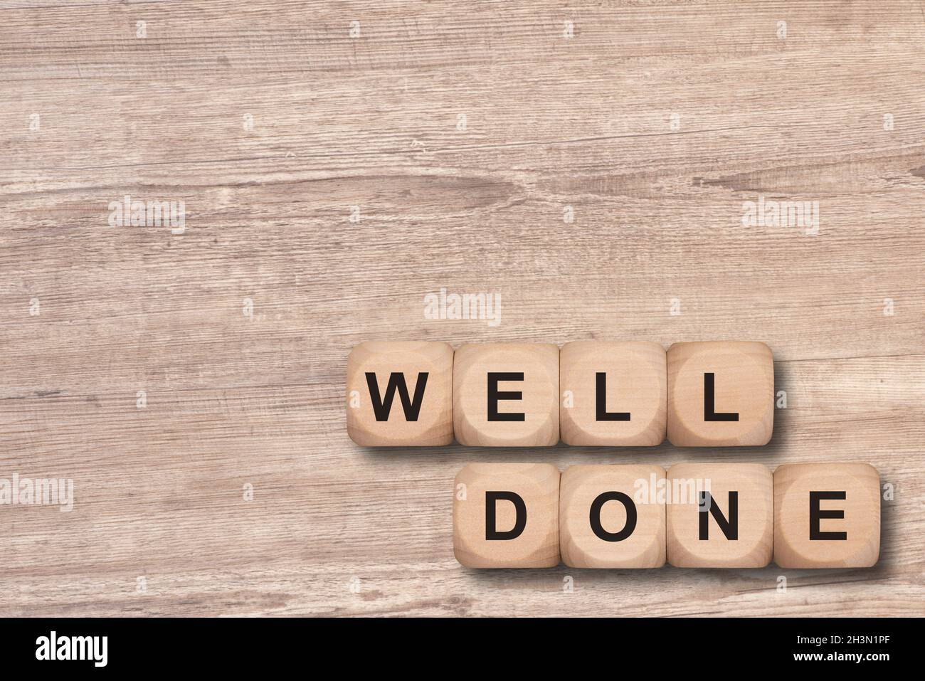 Well done written on wooden cubes Stock Photo - Alamy