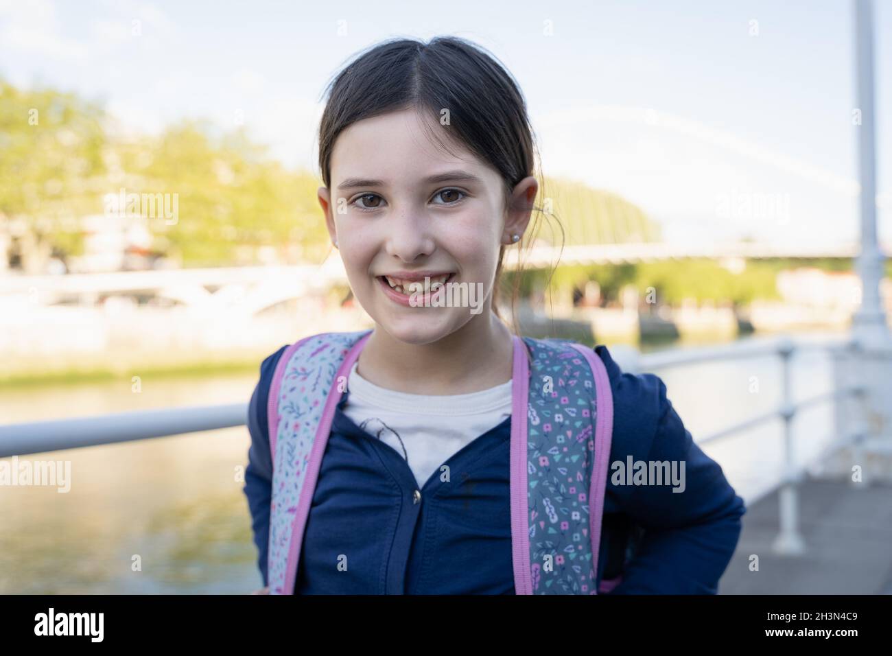 Portrait of smiling young child carrying school backpack. Happy little ...