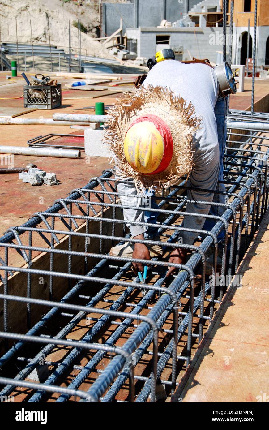 Concrete mason preparing a new steel grade beam for concrete Stock ...