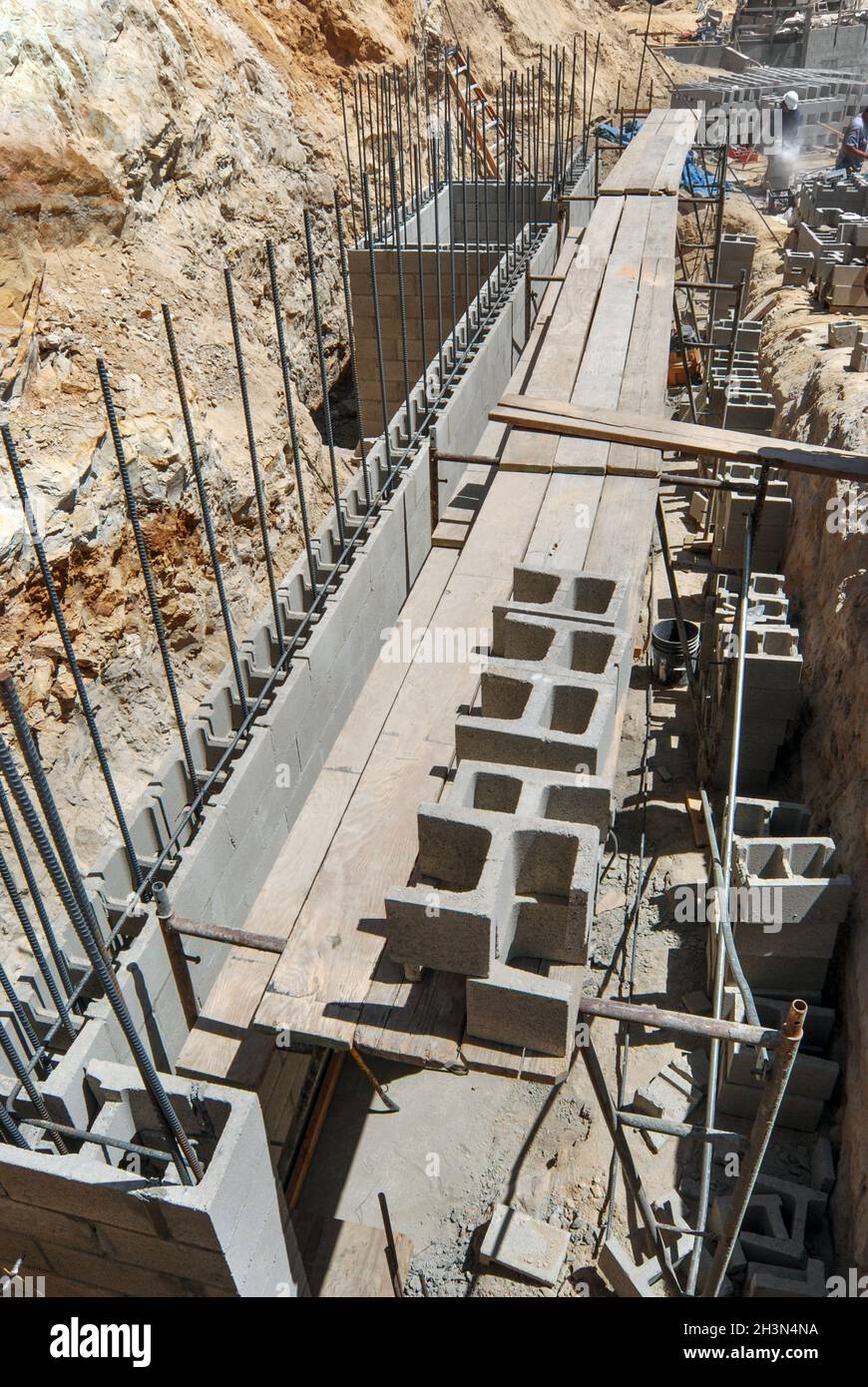 Building a new structural retaining wall on a hillside construction ...